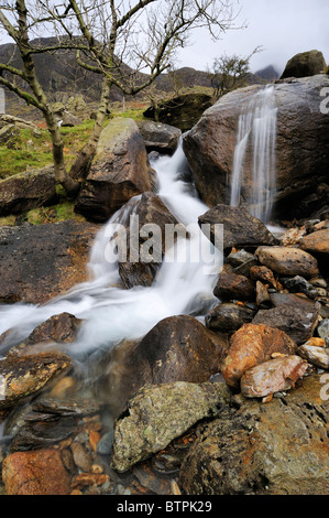 Waterfalls on Afon (River) Cwm Llan showing old slate quarry building ...
