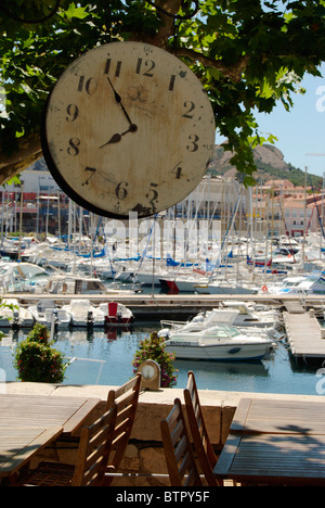 A table at an outdoor restaurant with a view of boats in the marina on ...