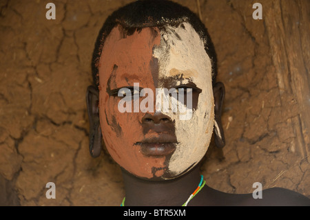 Portrait of young Suri / Surma woman with ritual scarification on chest ...