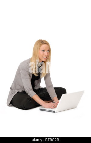 Young adult woman using a laptop and phone at a park table Stock Photo ...