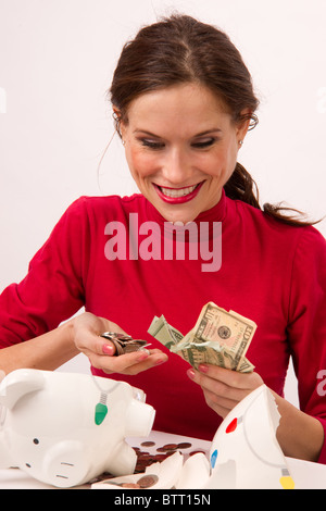 Pretty woman counts cash from piggy bank Stock Photo - Alamy