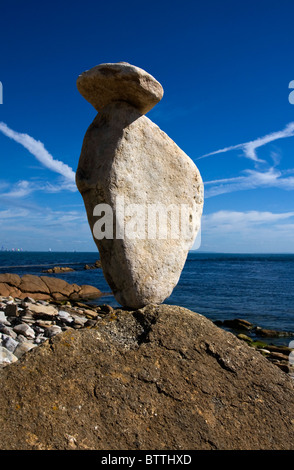 rock balancing on the coast by the sea, a concept of balance and ...