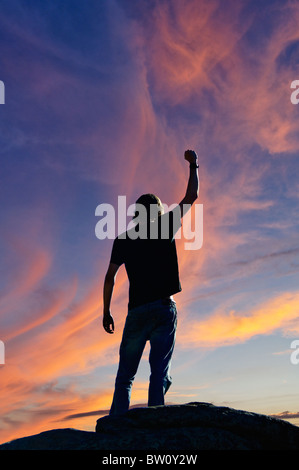 Young Man Throwing his Fist in the Air in Celebration After Climbing ...