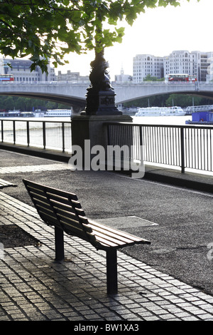 A bench by the River Thames in London with a view of Tower Bridge and ...