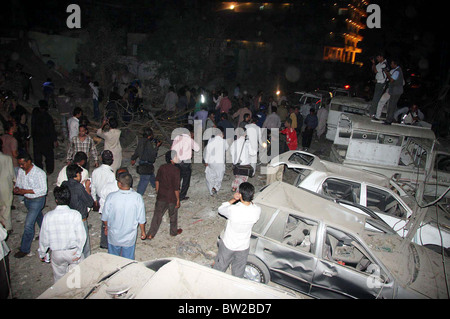 People gather at the site of a destroyed building that was hit in an ...