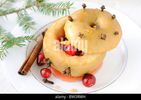 Baked Apple decorated with a cinnamon stick and a metal spoon on a ...