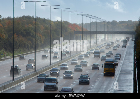 M25 motorway busy road traffic & proliferation of signs on four lane ...