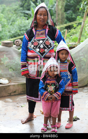 A family dressed in traditional Dai clothing near the town of ...