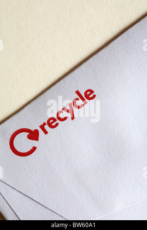 Red recycling arrow symbol on piece of cardboard Stock Photo - Alamy