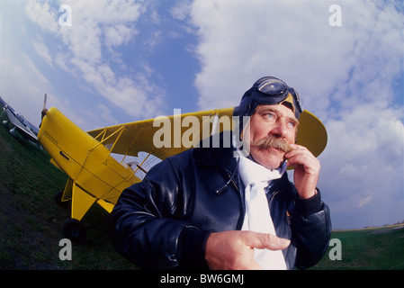 French pilot scratching his mustaches front of his biplane Stock Photo ...