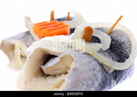 Two delicious pickled herring rollmops with vegetables isolated on ...