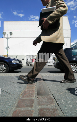 GERMANY BERLIN A businessman crossing the street while using his ...