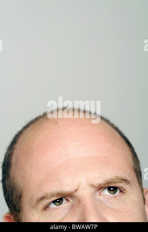 A portrait showing a man with a contemplative look, captured in ...