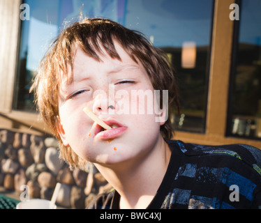 Defiant and hungry young boy age 8 waiting for brunch St Paul Minnesota ...