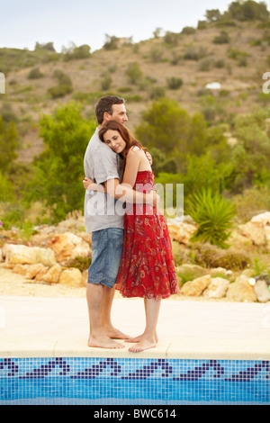 Couple hugging in swimming pool Stock Photo - Alamy