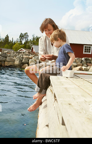 Two people fishing from a jetty at Lake Dunstan, Cromwell, Central ...