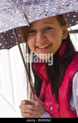 happy teen girl under colorful umbrella in autumn season hold toy ...