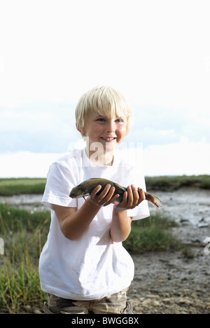 Boy holding fish Stock Photo: 73148116 - Alamy