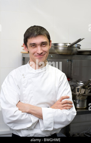 European chef with crossed arms looks smiling into camera Stock Photo ...