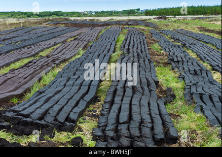 Peat turf bog lands machine cut turf Ireland Stock Photo - Alamy