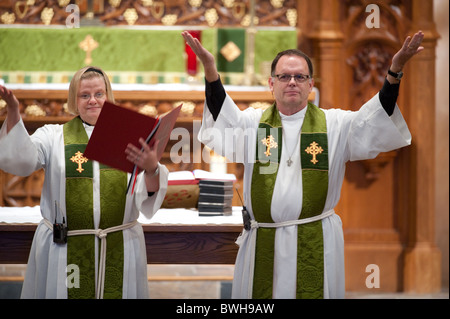 Anglo male minister and Anglo female assisting minister on pulpit ...