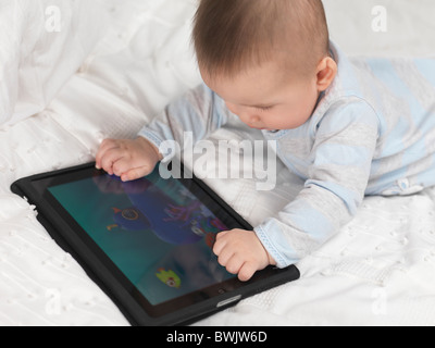 young male boy using ipad mini tablet computer Stock Photo: 84296159 ...
