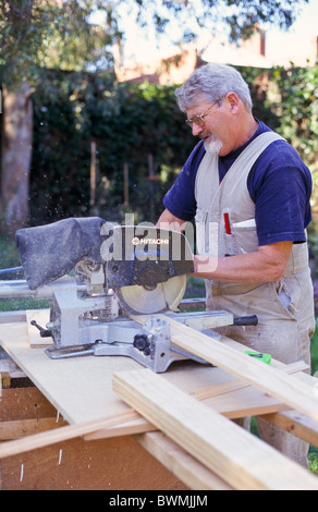 Carpenter measures wooden planks in the workshop Stock Photo - Alamy