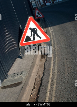 Road works sign on the road. Repair work of road signs and a bypass ...