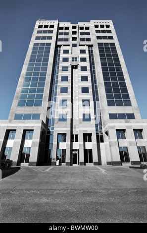 A large white high - rise building in the center, surrounded by other ...