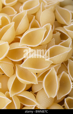 Pile of uncooked dry pasta conchiglie isolated on a white Stock Photo ...