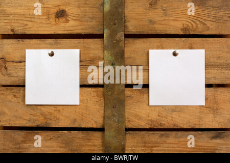 Two pieces of blank paper tacked to wooden background.Ready for your ...