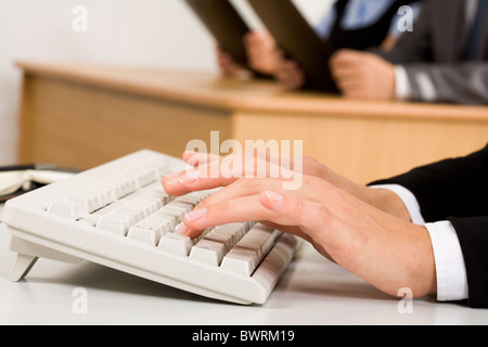 Image of female’s hands pushing buttons of computer keyboard in office ...
