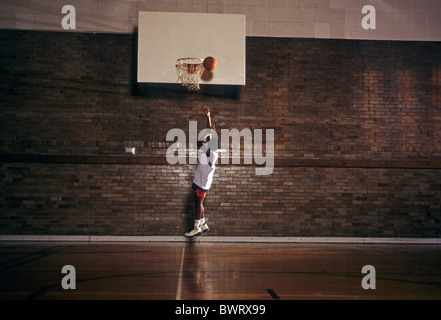 Young boy practicing his basketball shooting Stock Photo - Alamy