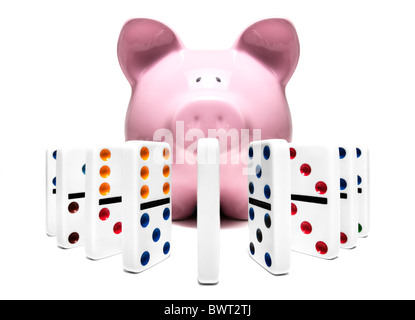 Piggy bank surrounded by dominoes Stock Photo - Alamy