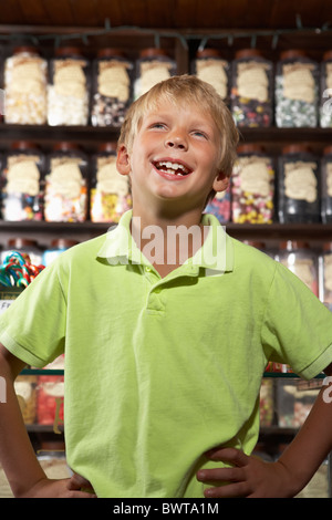 Excited Boy Standing In Sweet Shop Stock Photo - Alamy