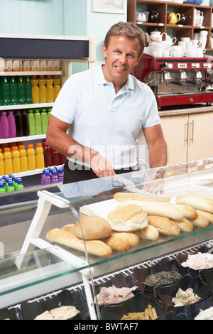 Man Working Behind Counter In Delicatessen Taking Food Order Stock ...