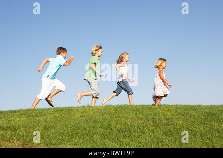 Young boy running through a field of Indian Paintbrush and Bluebonnet ...