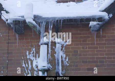 Icicles hanging from snow covered roof Norfolk Stock Photo - Alamy