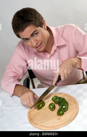 A vertical shot of a male cutting a dessert Stock Photo - Alamy