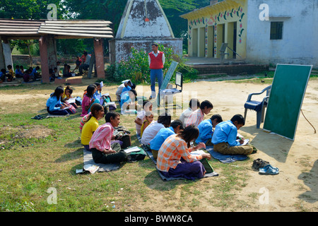 Rural Indian village school teacher and children in an outside class ...