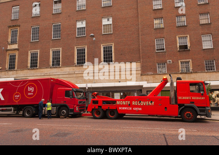 A broken down HGV lorry getting ready to be towed away by a recovery ...