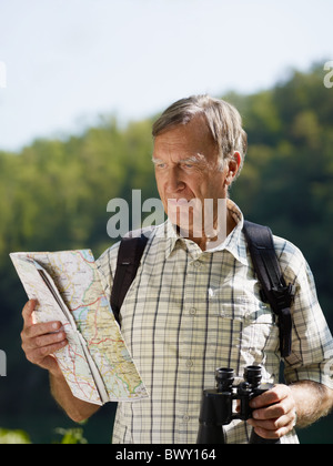 senior hiker holding map and binoculars. Copy space Stock Photo - Alamy