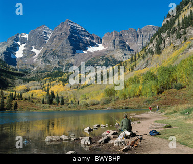 man fishing Maroon Bells mountain range near Aspen Colorado USA Stock ...