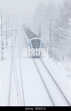 Train passing through winter landscape Stock Photo - Alamy