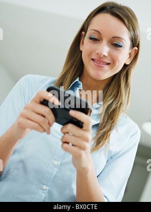 young businesswoman reading emails on her smartphone. isolated on white ...