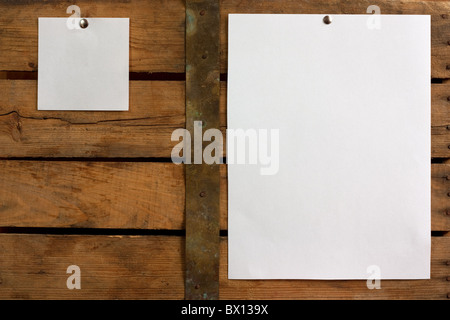 Two pieces of blank paper tacked to wooden background.Ready for your ...