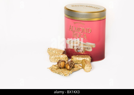 Almond Roca candy is displayed in front of a pink box filled with the ...