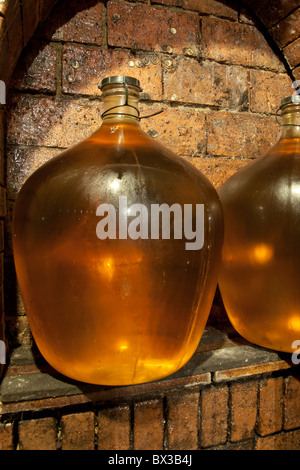 Grapes and red wine in a demijohn Stock Photo - Alamy