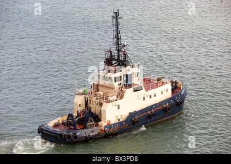Tugboat pulling ship away from Quayside Civitavecchia Italy Stock Photo ...