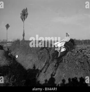 Czechoslovakia," Velka Pardubicka" steeplechase. Jockey nogotiates ...